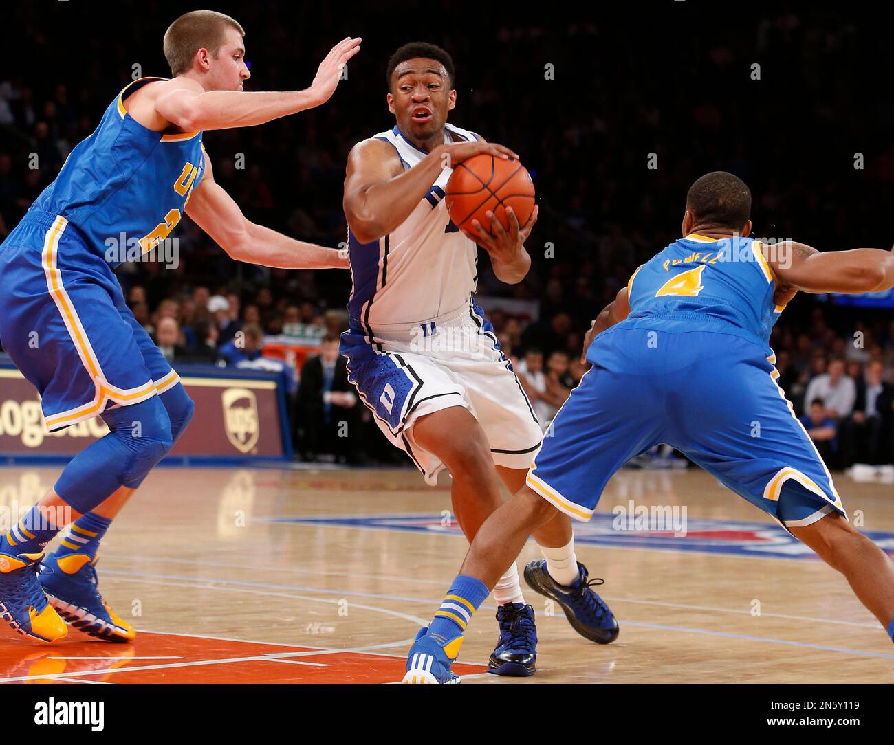 Duke's Jabari Parker, center, drives between UCLA's Travis Wear, left ...