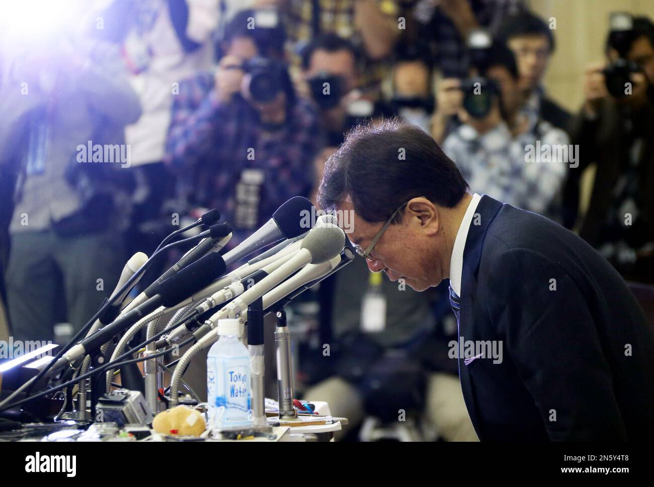 Tokyo Gov. Naoki Inose bows during a press conference to announce his ...