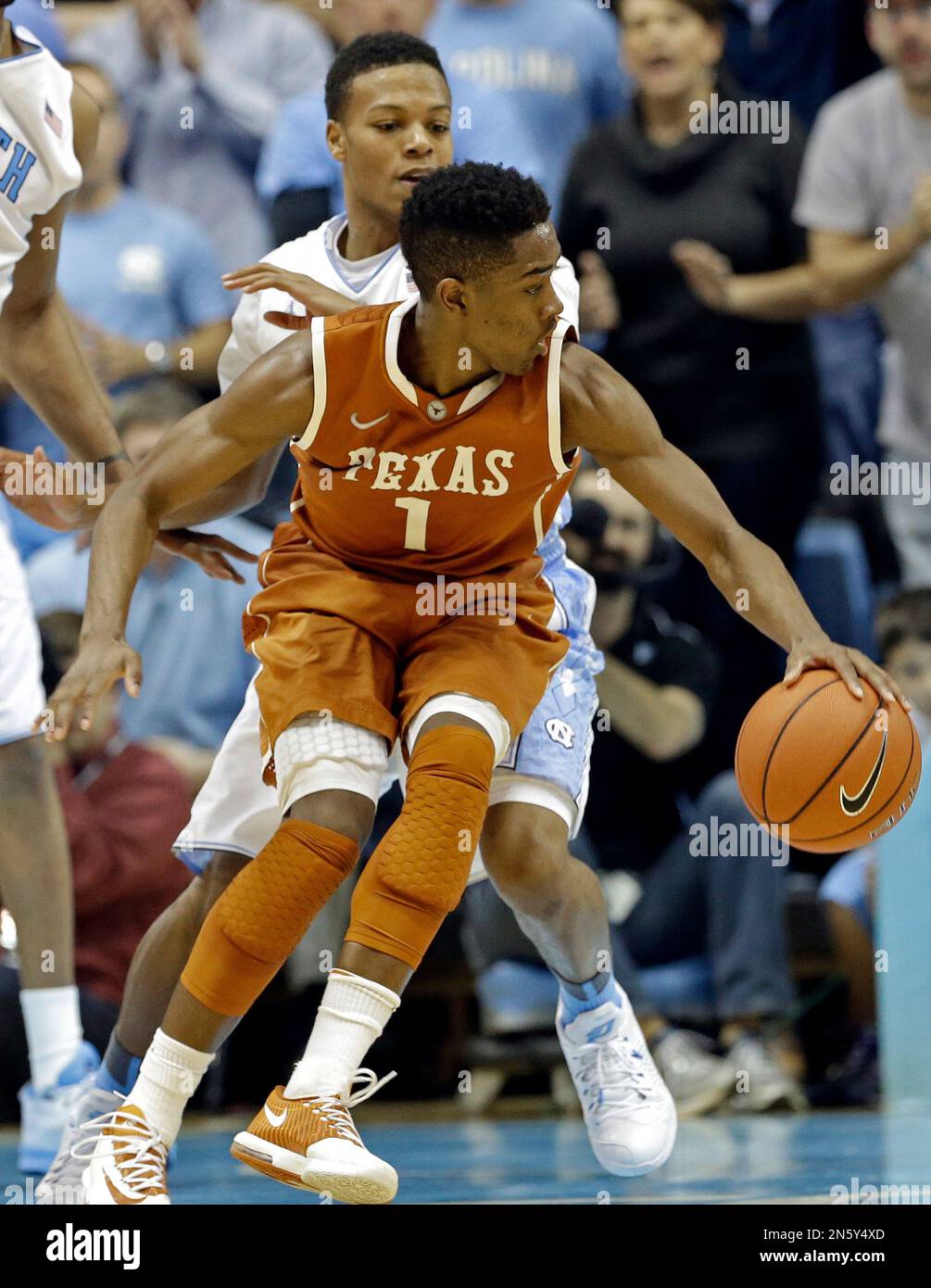 Texas' Isaiah Taylor (1) is guarded by North Carolina's Nate Britt ...