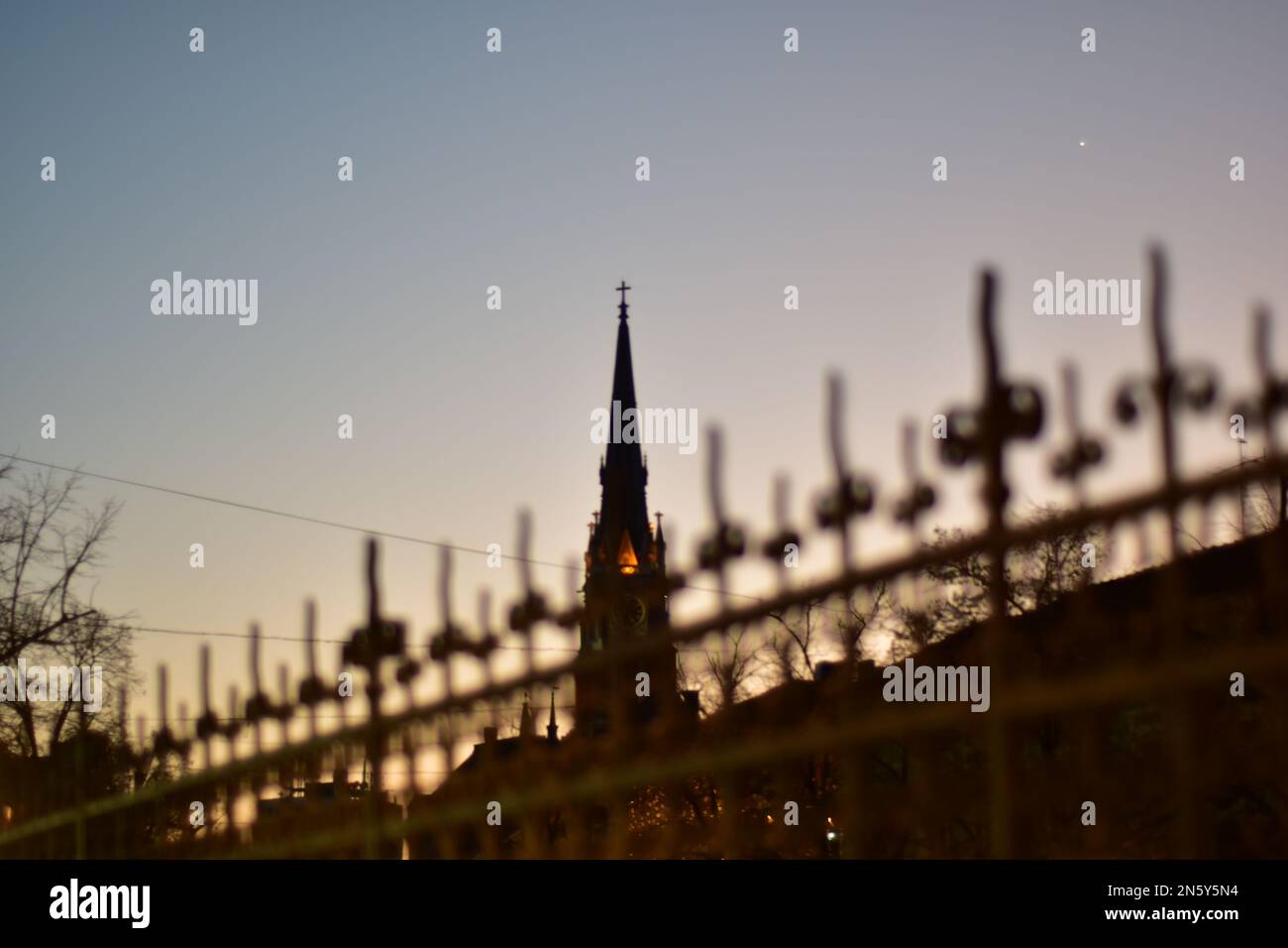 Medieval styled steel fence with a cathedral in the backgrounds on a ...
