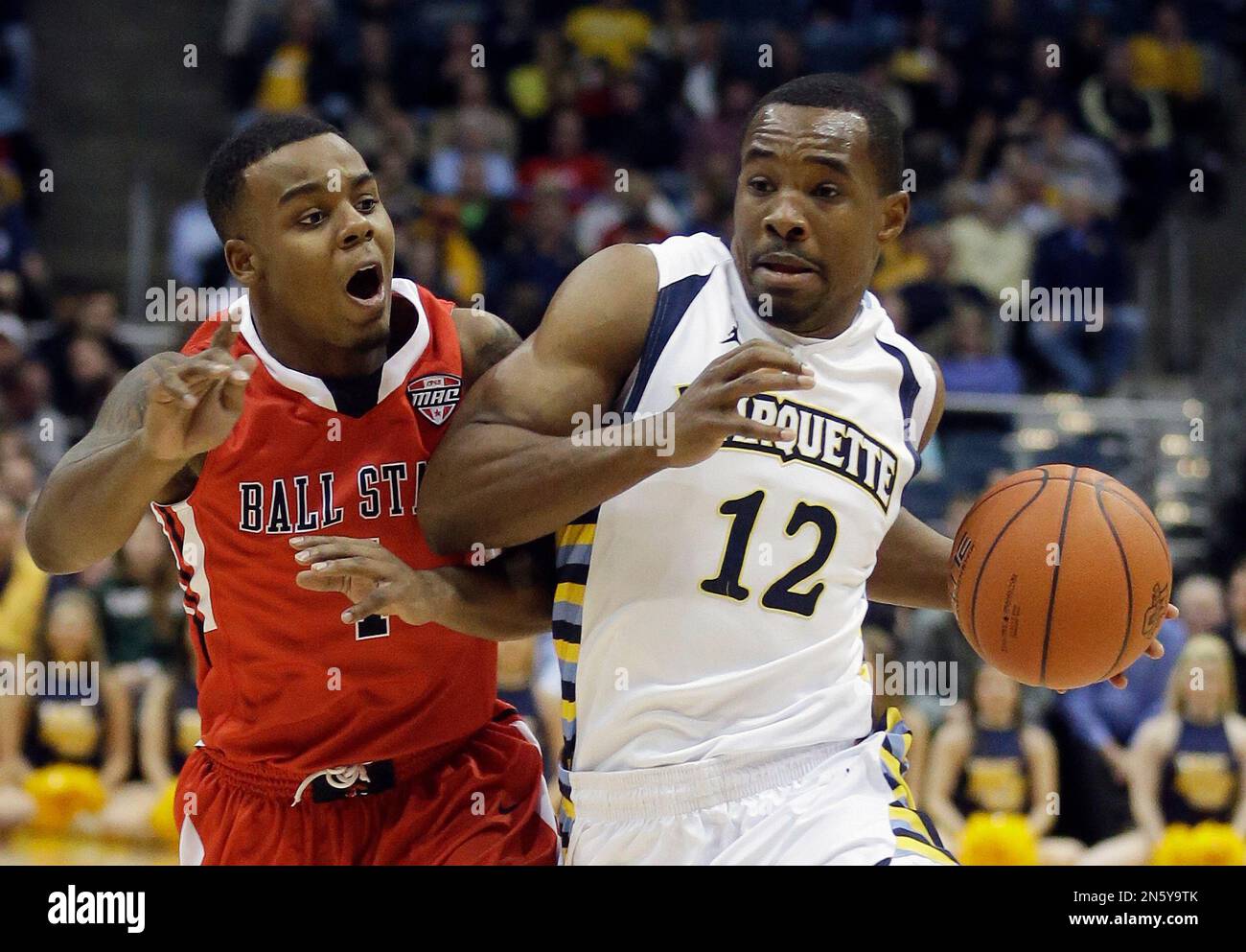 Marquette's Derrick Wilson (12) drives past Ball State's Zavier Turner ...