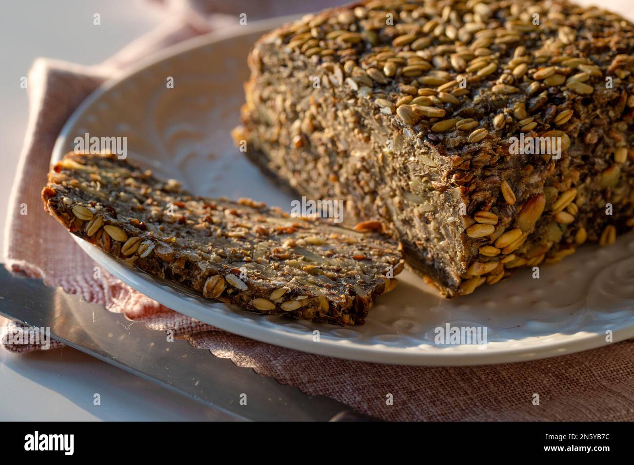 Fresh grain bread cut on the plate Stock Photo - Alamy