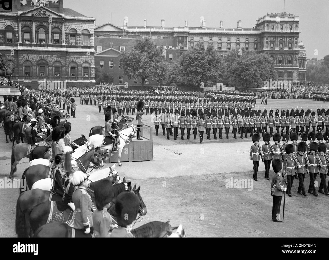 Britain's King George VI, centre on rostrum, takes the salute during ...