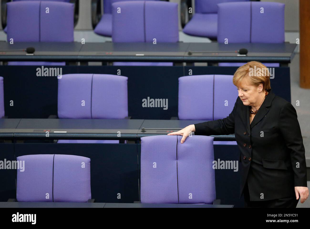 Reelected German Chancellor Angela Merkel takes her seat at the ...