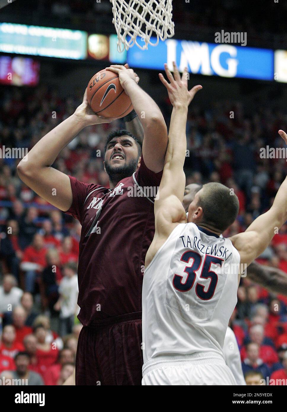 New Mexico States' Sim Bhullar (2) attempts a shot against the defense ...