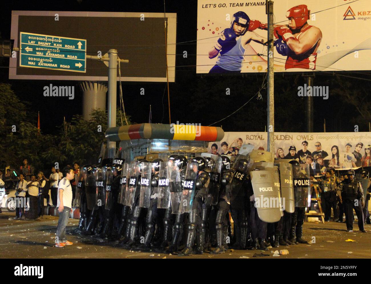 Myanmar riot police stand guard near Thuwunna stadium, in Yangon ...
