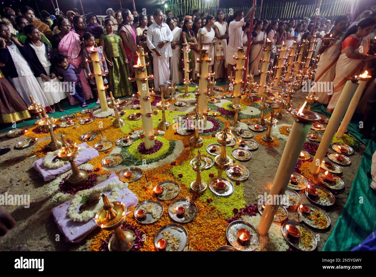 In this Sunday, Dec. 15, 2013 photo, Indian devotees wait to perform ...