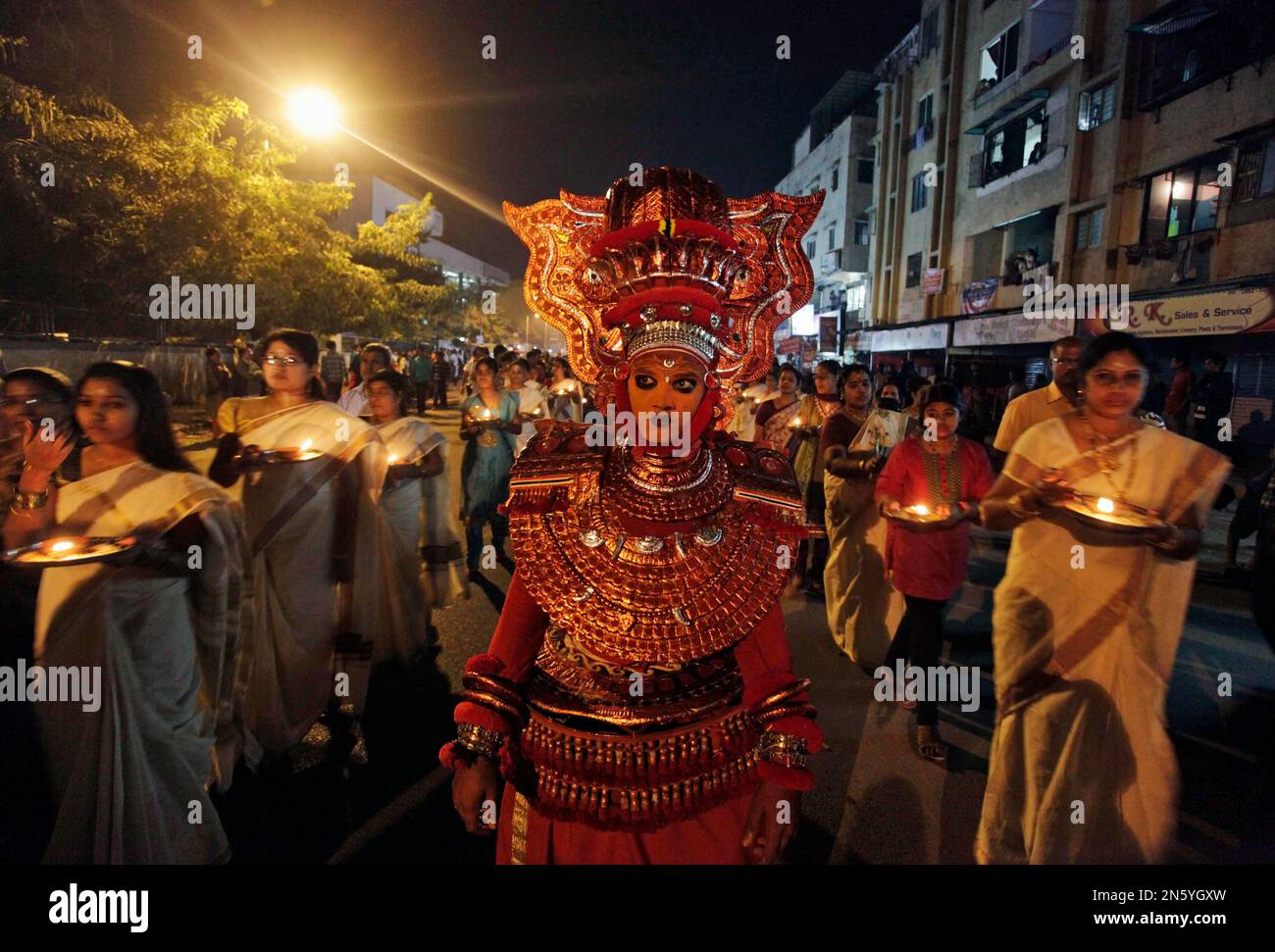 In this Sunday, Dec. 15, 2013 photo, an Indian performer of Theyyam ...