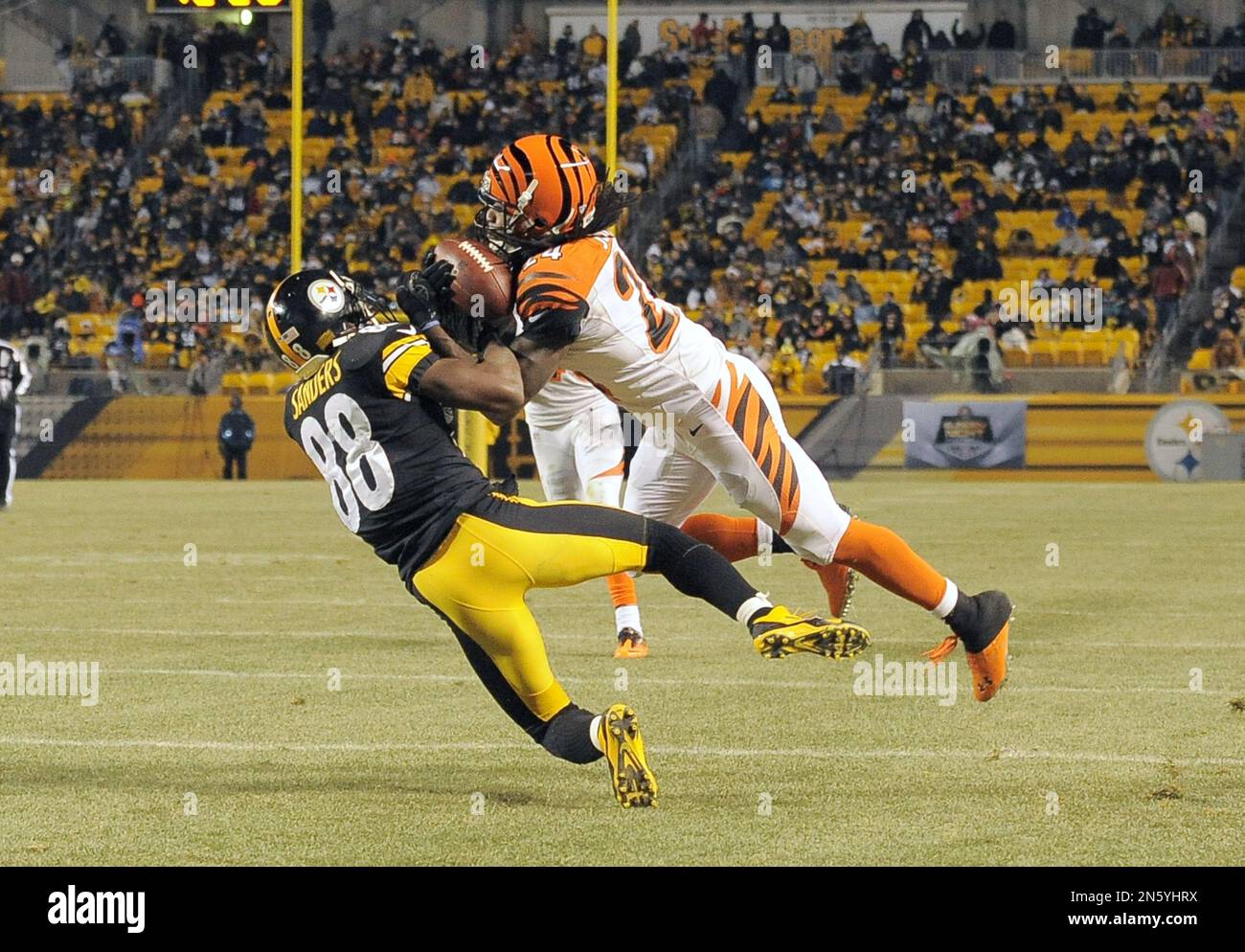 Cincinnati Bengals cornerback Adam Jones (24), top, intercepts a pass ...