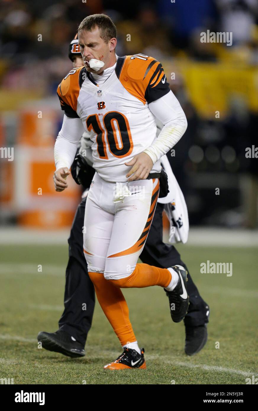 Cincinnati Bengals punter Kevin Huber (10) is taken from the field ...