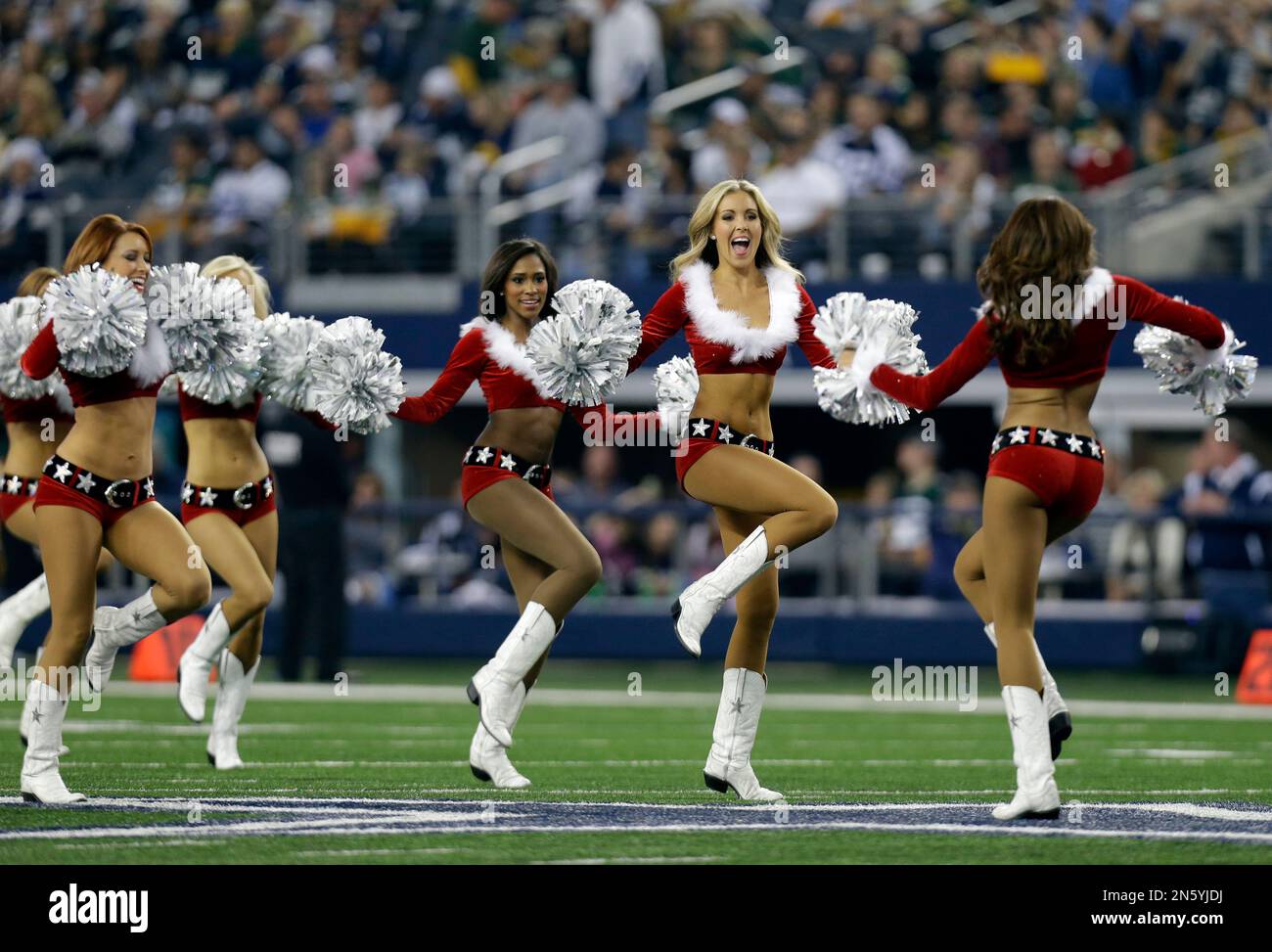 Members of the Dallas Cowboys cheerleaders perform at halftime of an ...