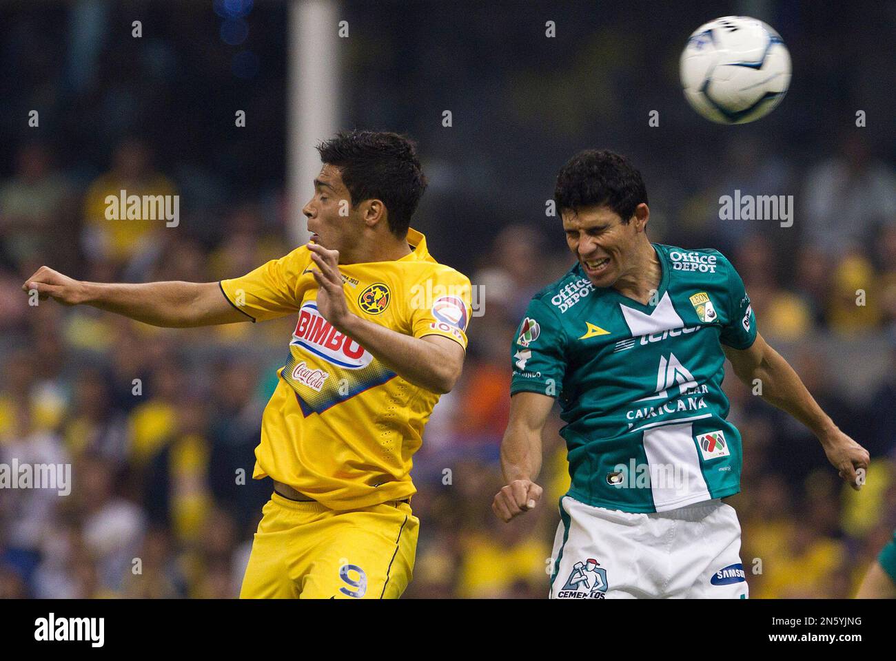 America´s Raul Jimenez, left, jumps for the ball with Leon´s Jhony ...