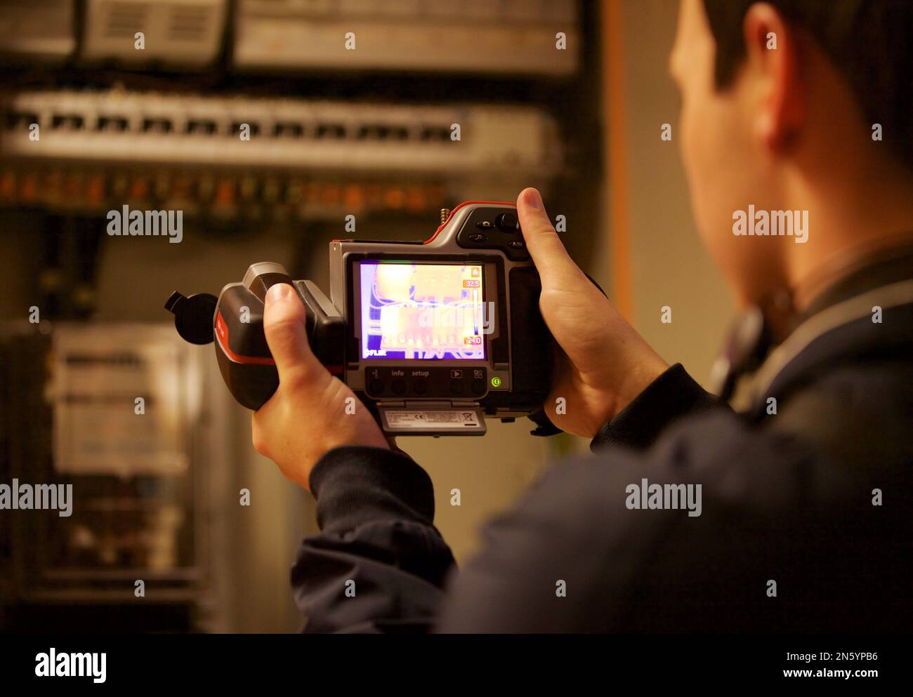 A man with thermal imaging camera checking electric installation Stock ...