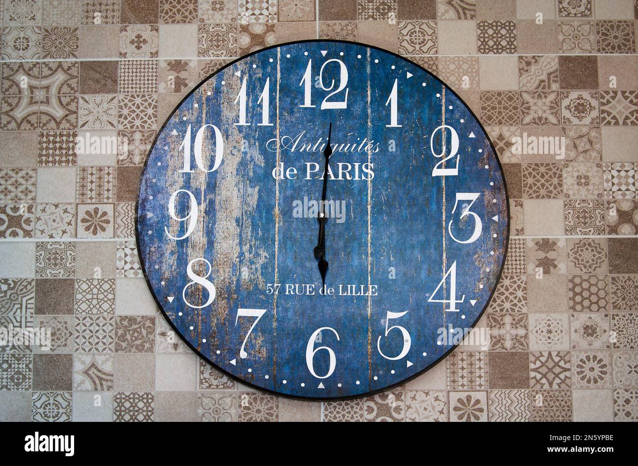 A blue vintage clock with white numbers hanged on wall Stock Photo - Alamy