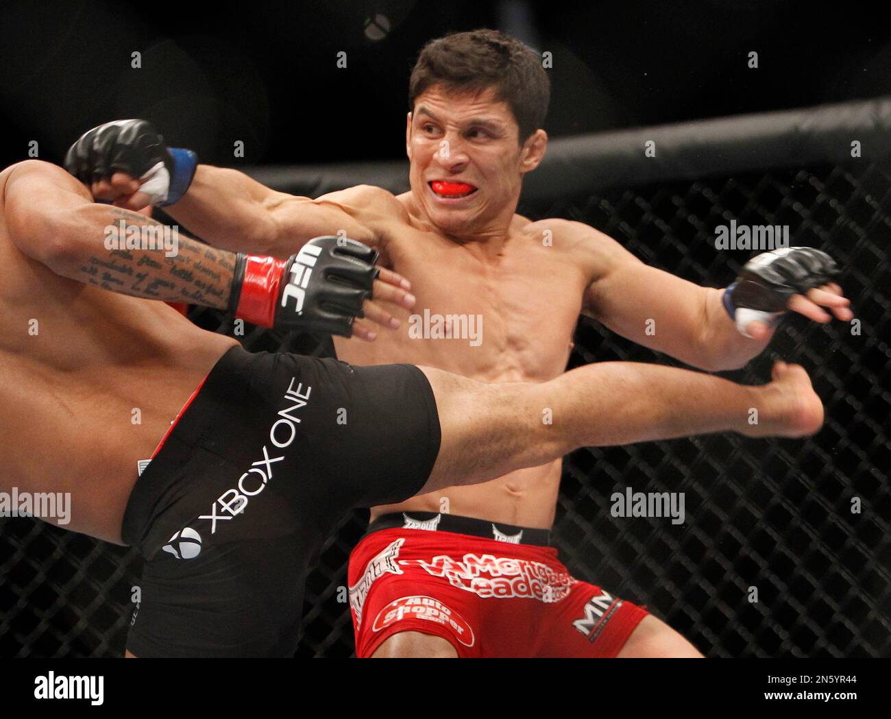 Joseph Benavidez throws a punch at defending champ Demetrious Johnson ...