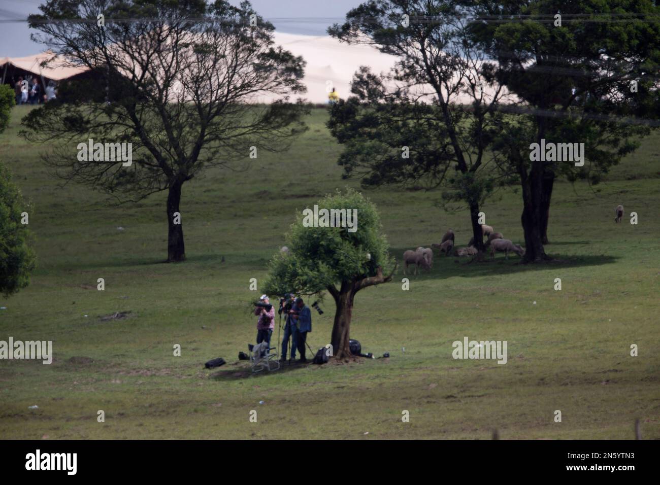 Three journalists take images of the burial of former South African ...