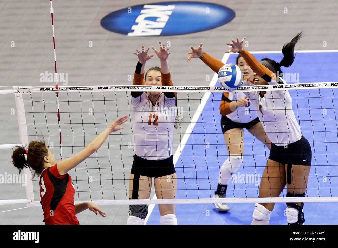 Texas' Khat Bell, right, and Hannah Allison (12) block a kill attempt ...