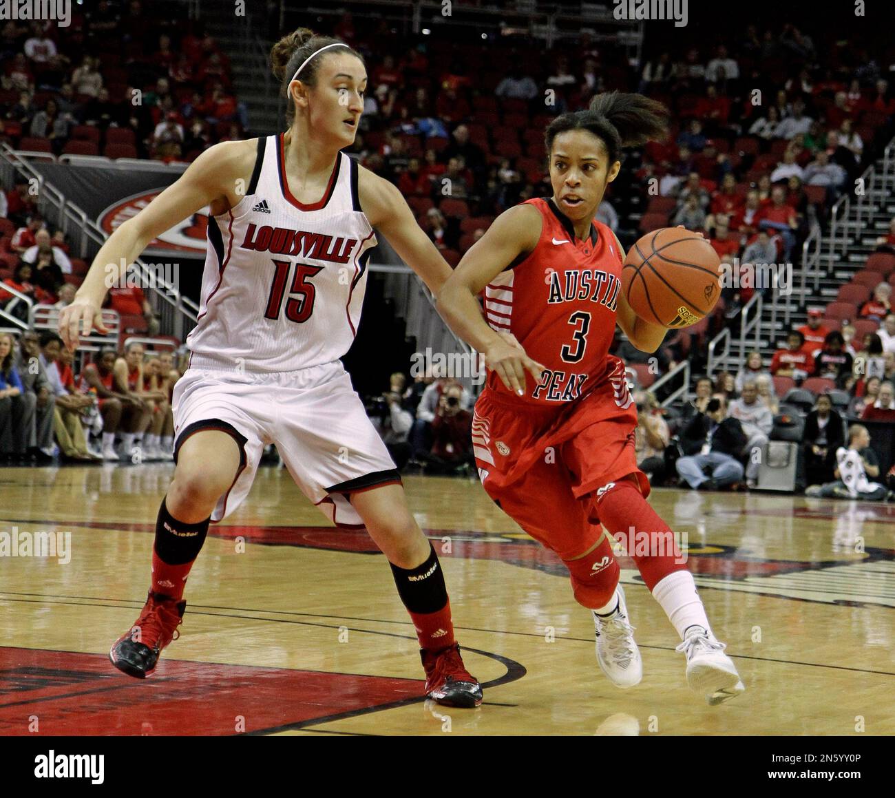 Austin Peay guard April Rivers (3) drives past Louisville defender ...