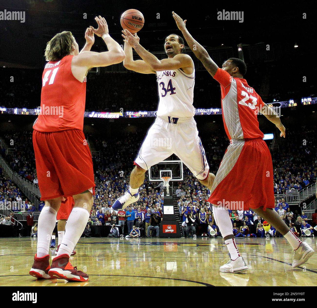 Kansas' Perry Ellis (34) shoots under pressure from New Mexico's ...