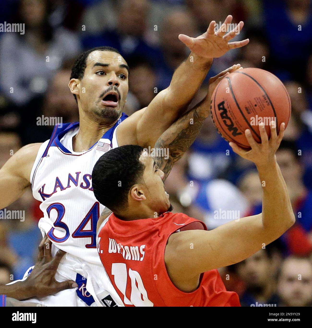Kansas' Perry Ellis (34) tries to block a shot by New Mexico's Kendall ...