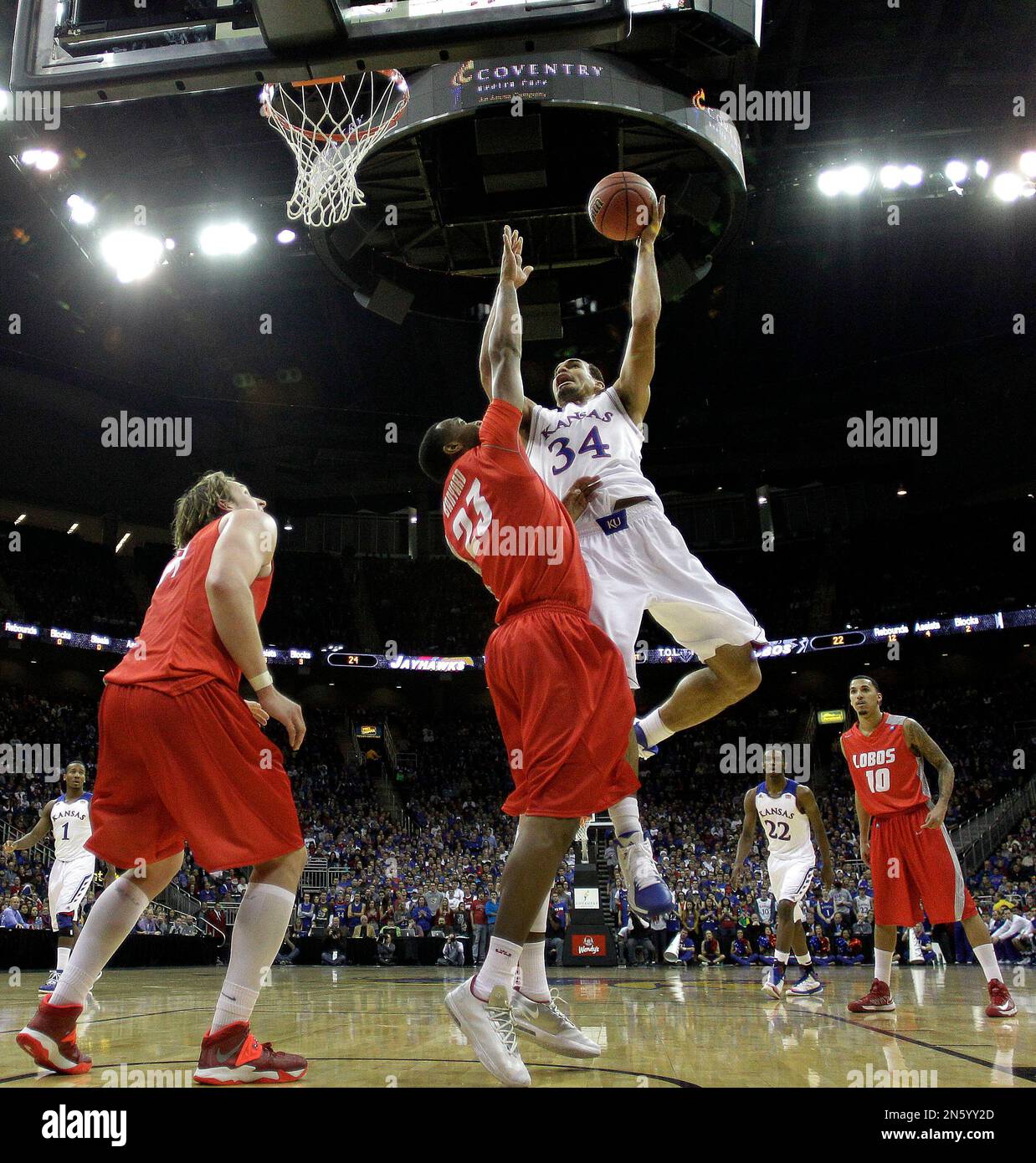Kansas' Perry Ellis (34) gets past New Mexico's Nick Banyard (23) to ...