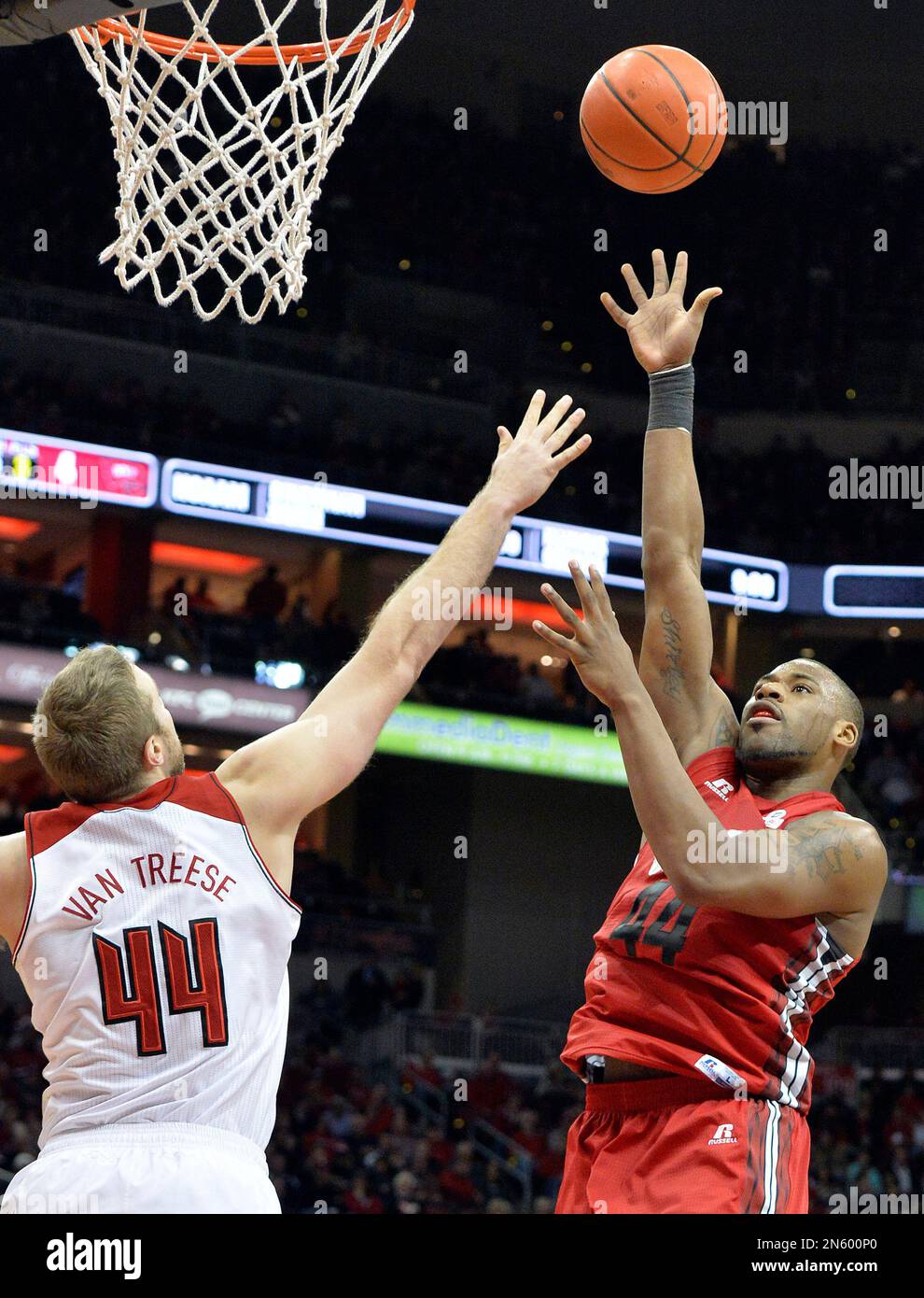 Western Kentucky's George Fant, right, puts a shot up over the defense ...
