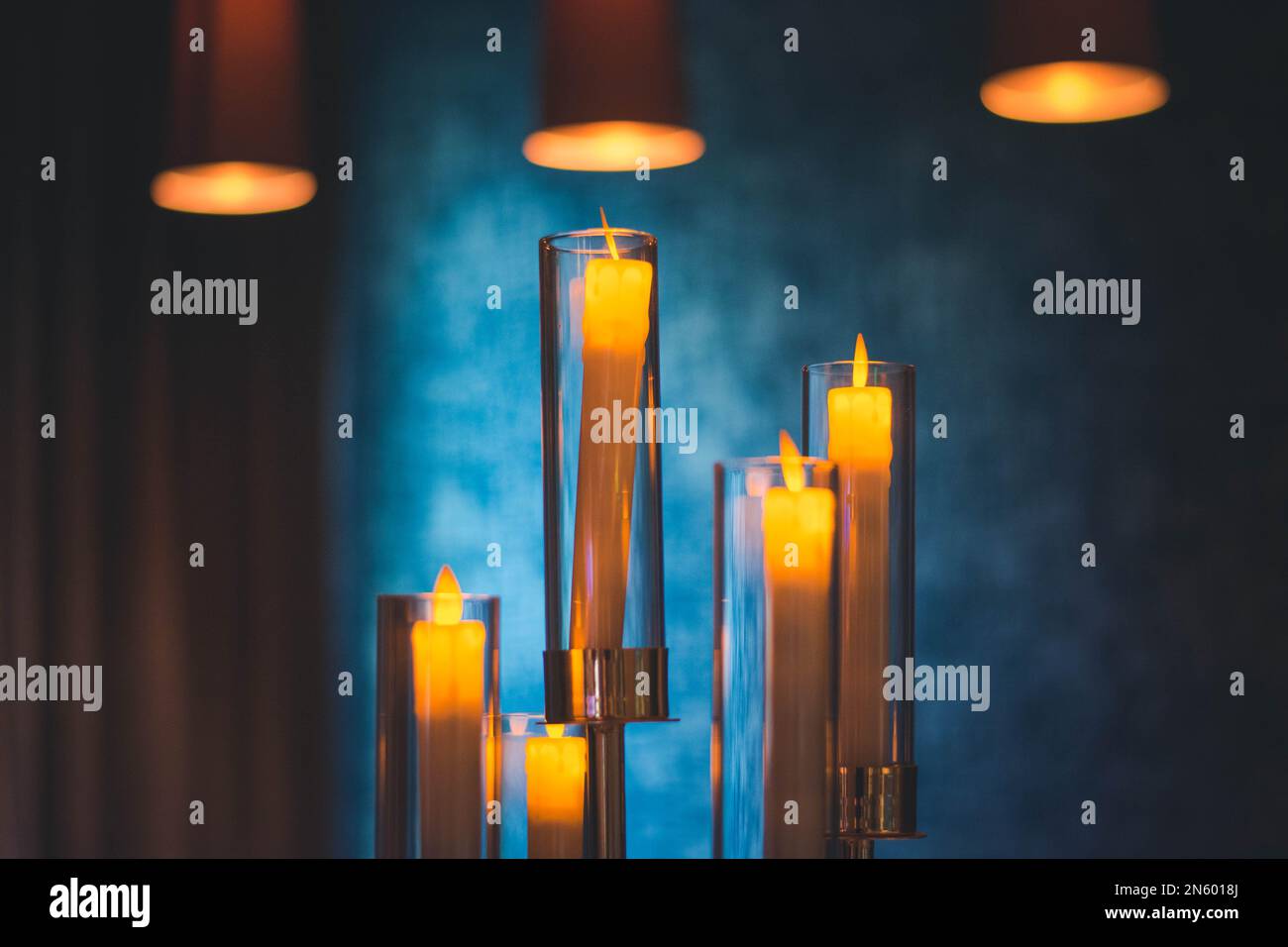 A beautiful long candles lighted on blur background Stock Photo - Alamy