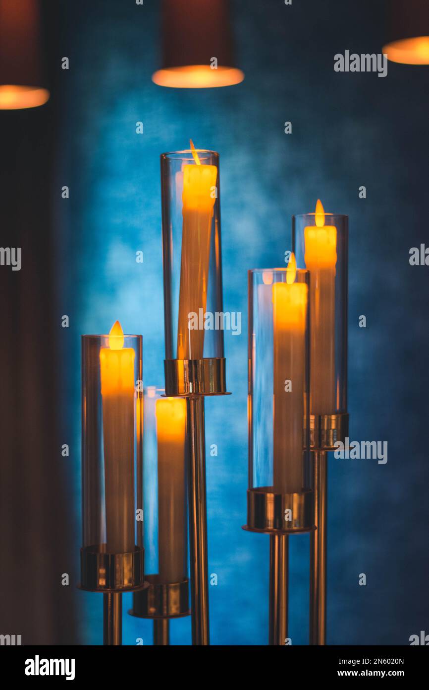 A vertical shot of long candles lighted on blur background Stock Photo ...