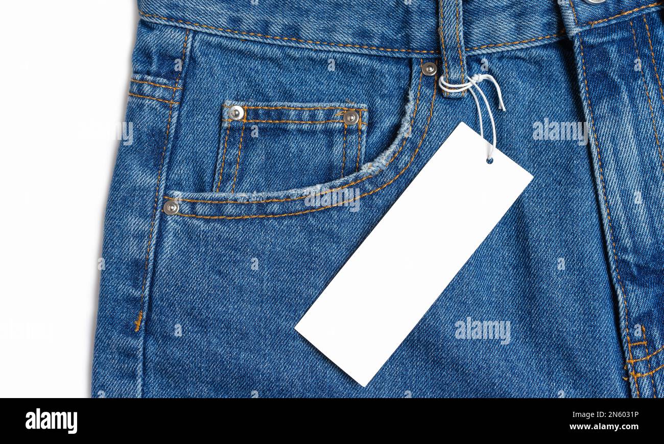 Front side pocket and price tag of blue jeans pants close-up isolated ...