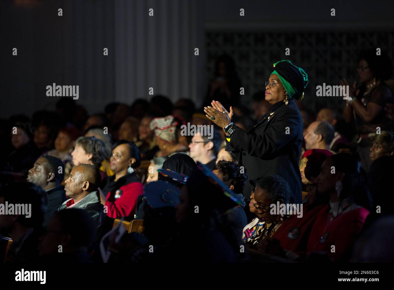 Audience members listen to speakers during a memorial service for ...