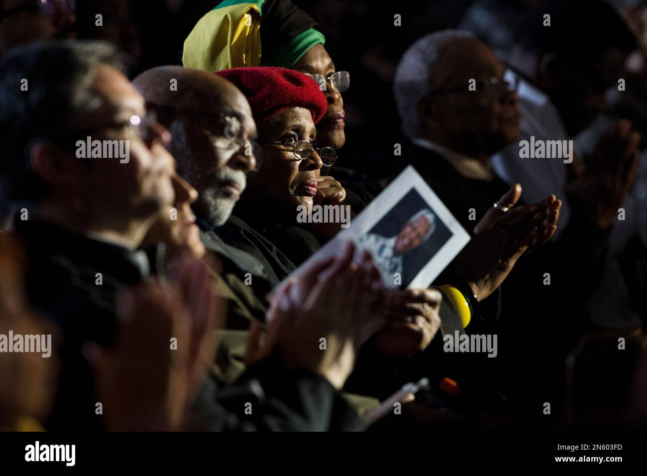 Audience members listen to speakers during a memorial service for ...