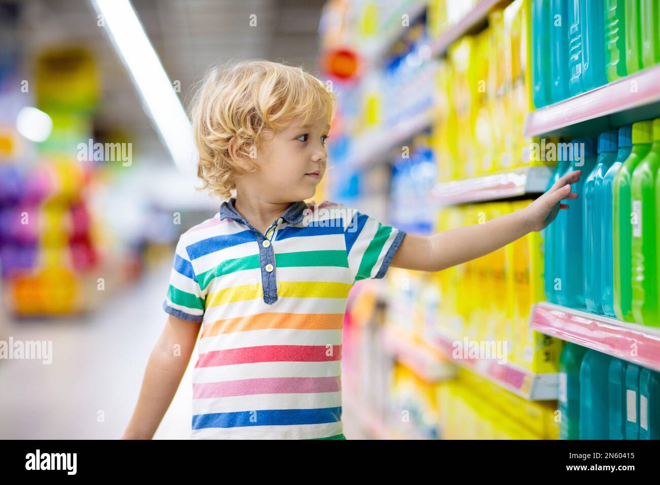 Child in supermarket buying fruit and juice. Kid grocery shopping ...