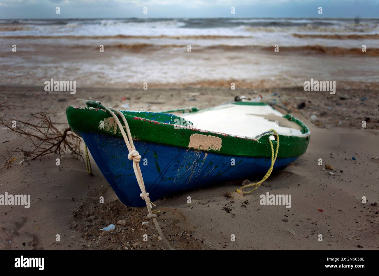 A fishing boat sits on the beach of Gaza City, Friday, Dec. 13, 2013 ...