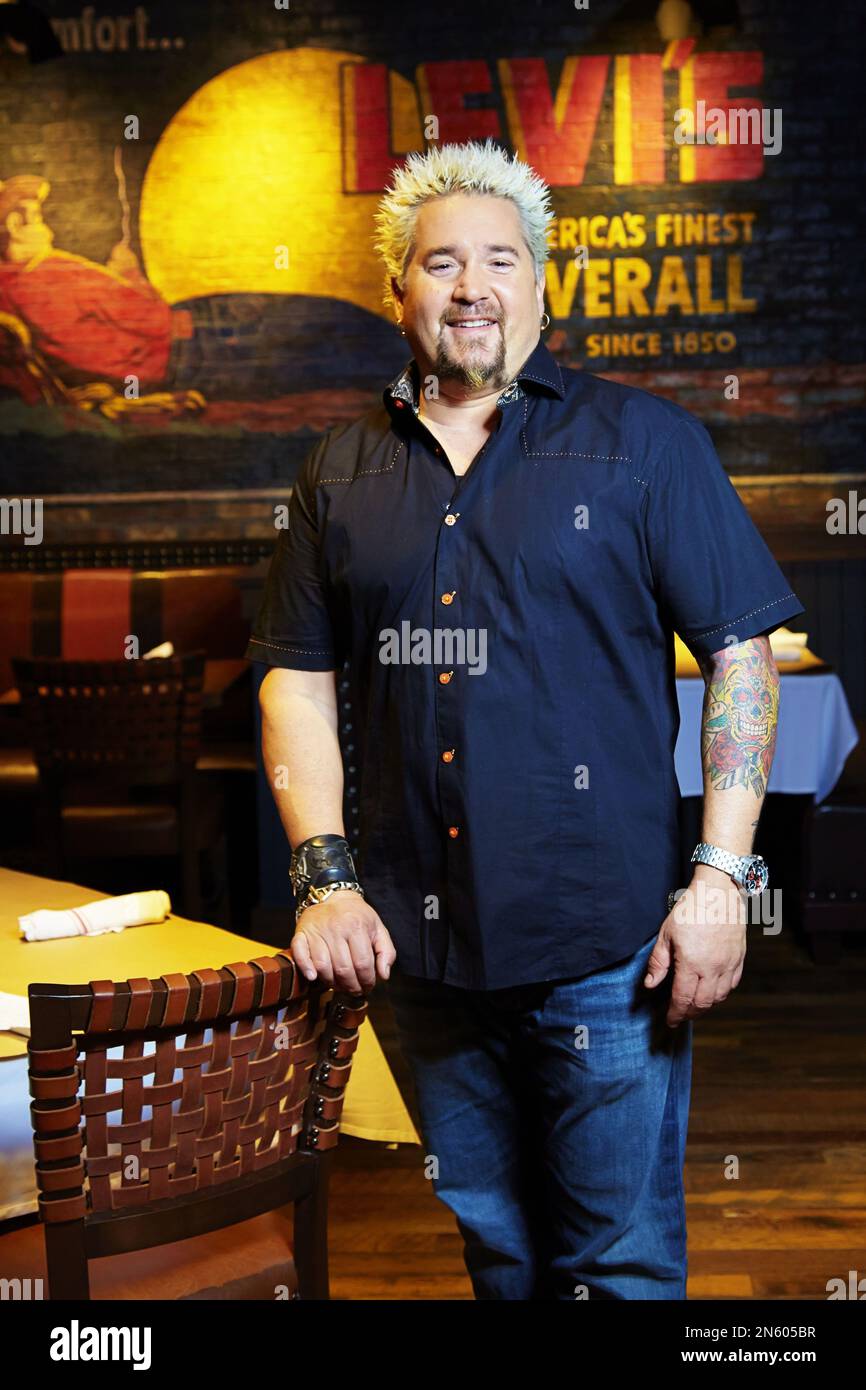 Guy Fieri poses for a portrait, on Monday, Dec. 9, 2013 in New York ...