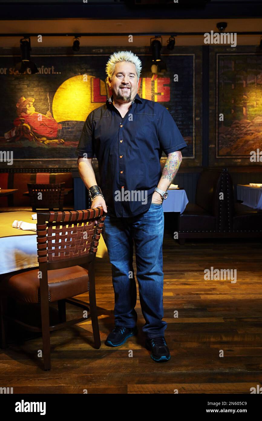 Guy Fieri poses for a portrait, on Monday, Dec. 9, 2013 in New York ...