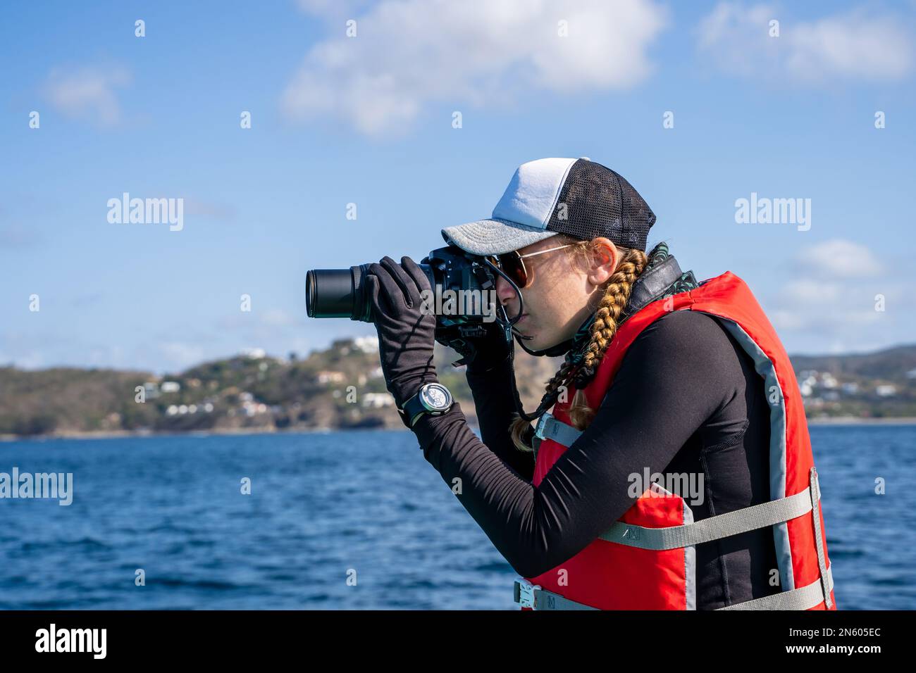 Profile of a female marine biologist taking photos on the sea Stock ...
