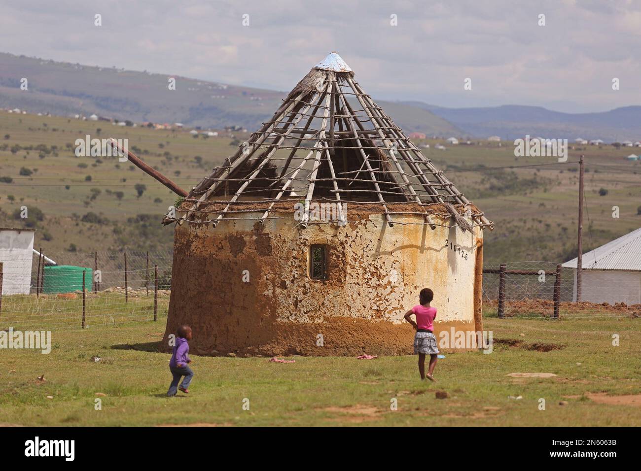 Children walk past an abandoned hut near the area were former South ...
