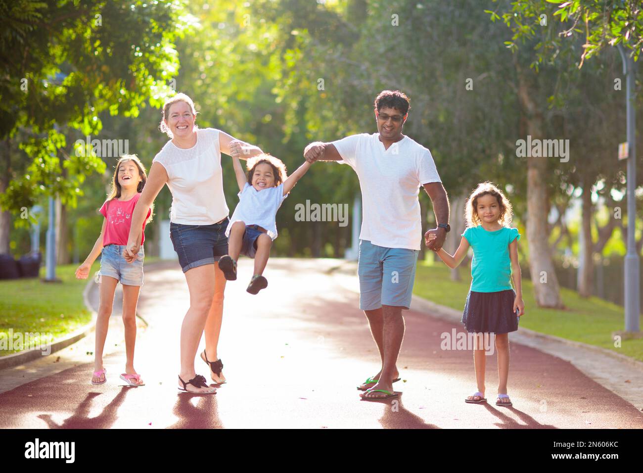 Family walking in summer park. Parents and kids outdoor. Mother, father ...
