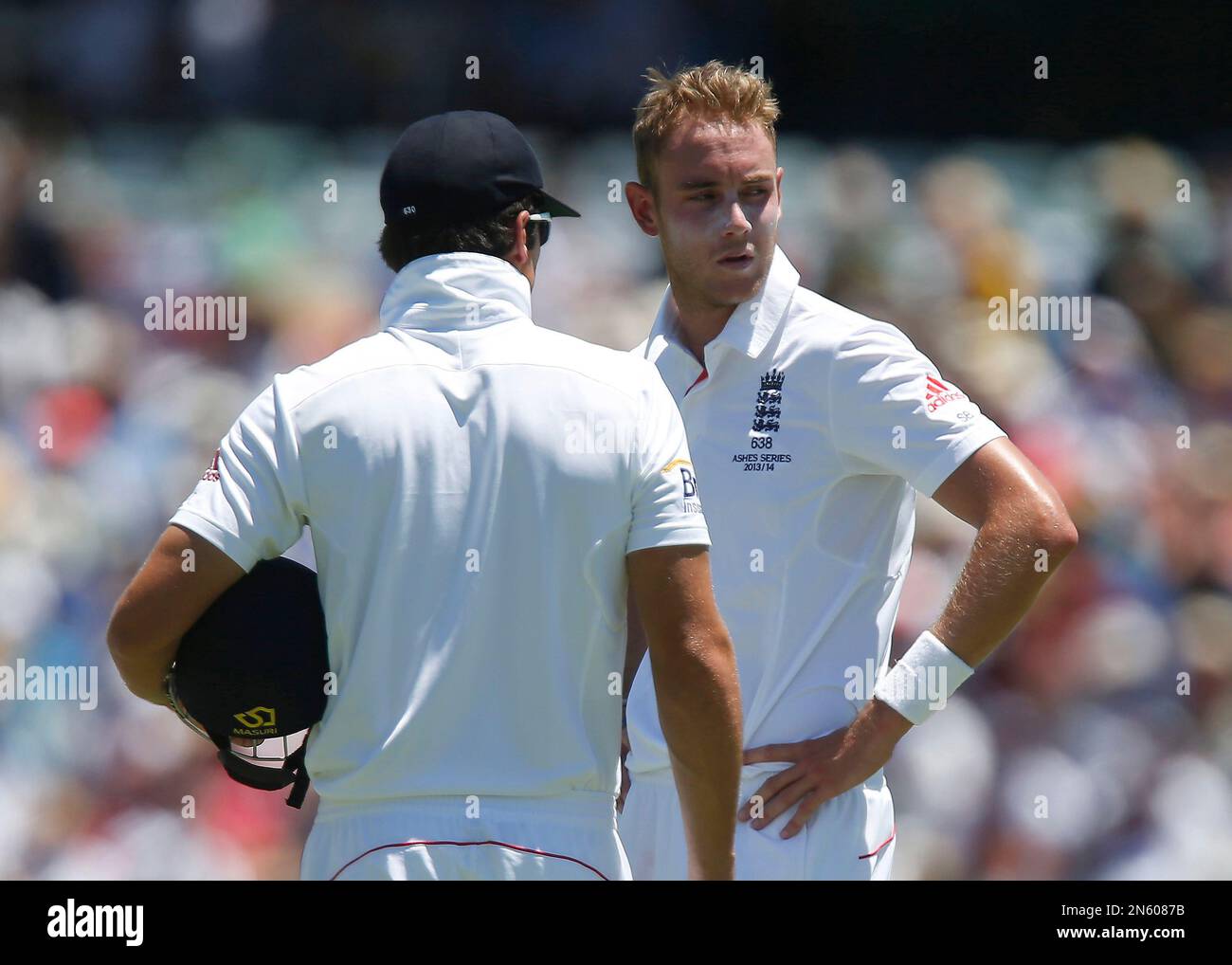 England's Stuart Broad, right talks tactics with captain Alastair Cook ...