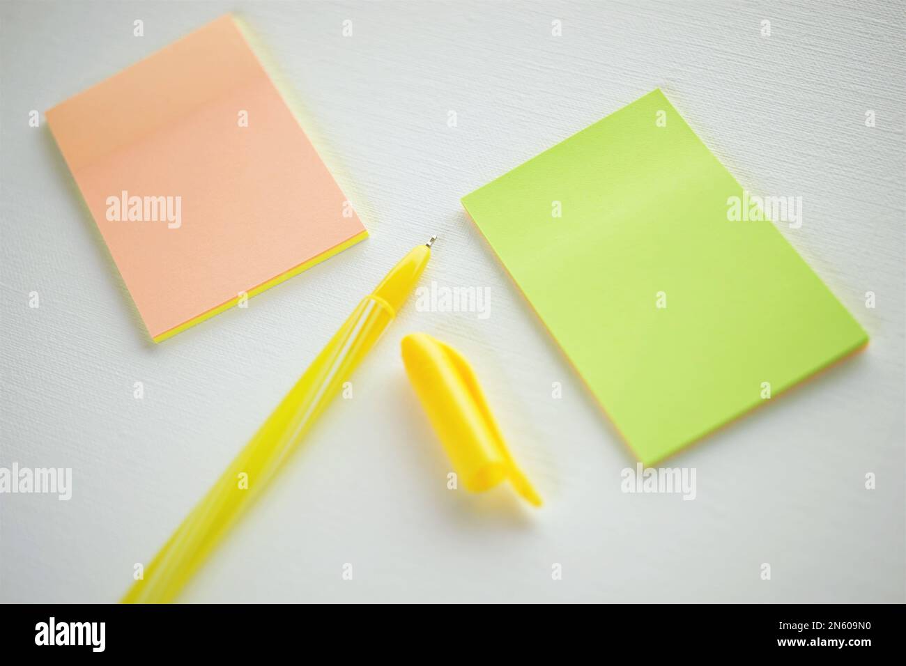 Yellow ballpoint pen and notes on white paper Stock Photo - Alamy