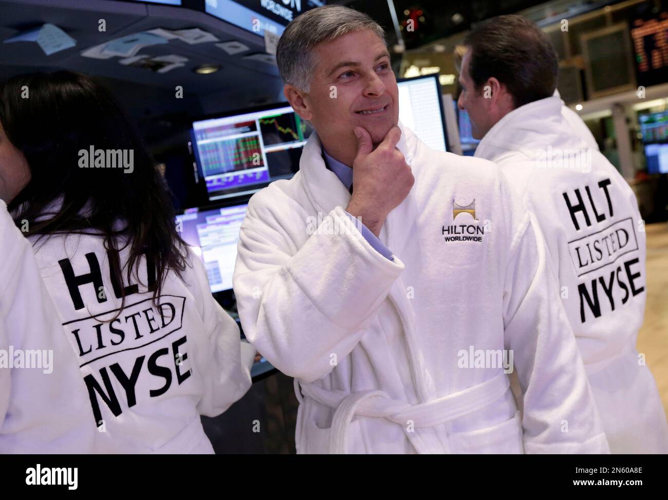 CEO of Hilton Worldwide Christopher Nassetta, center, poses in a Hilton ...