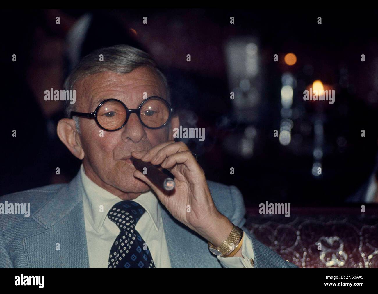 George Burns puffs on his cigar at Regine's on Park Avenue in New York ...