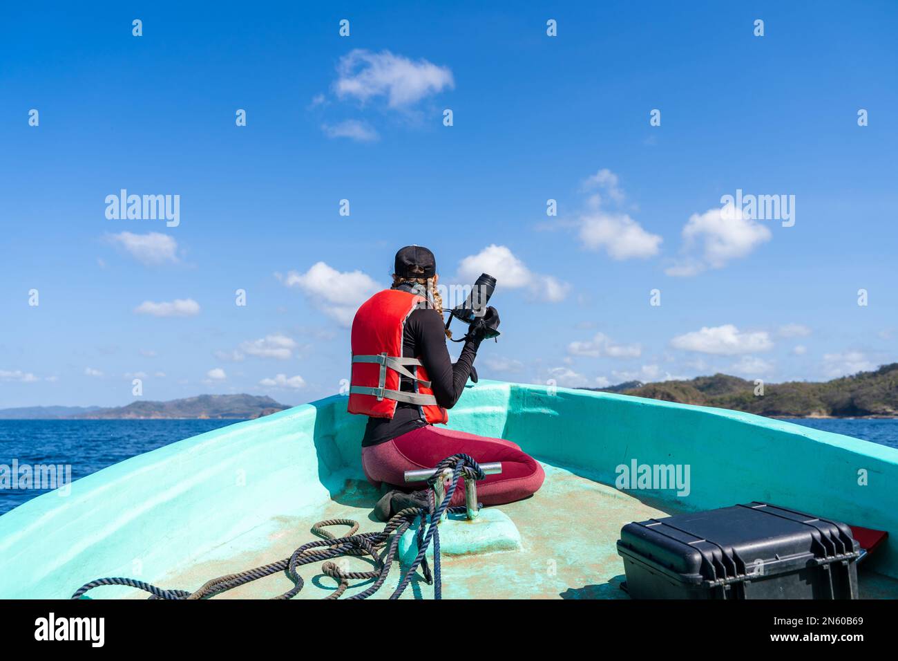 Rear view of an equipped marine biologist working while talking photo ...