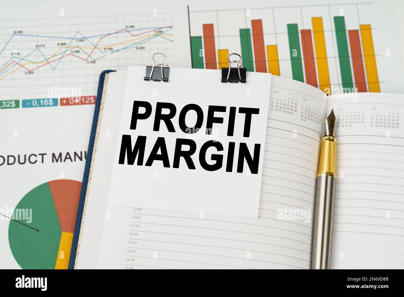 Business concept. On the business charts lies a pen, a notepad with ...