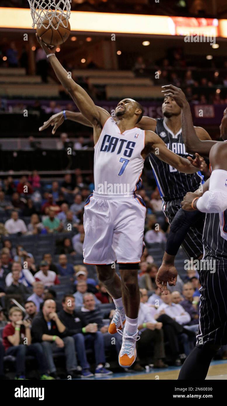 Charlotte Bobcats' Ramon Sessions, left, drives past Orlando Magic's ...