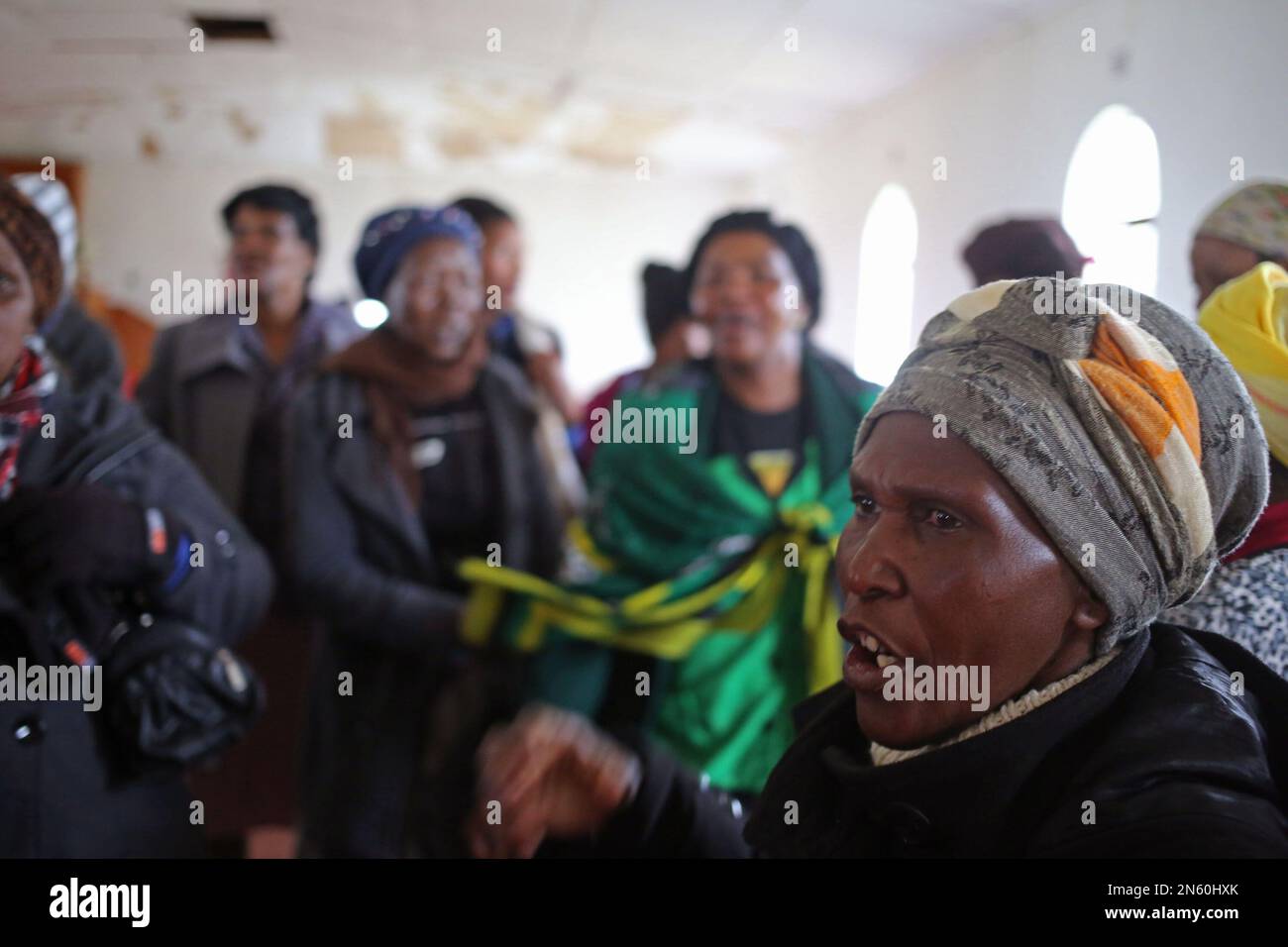 A woman sings with others as they celebrate the live of former South ...