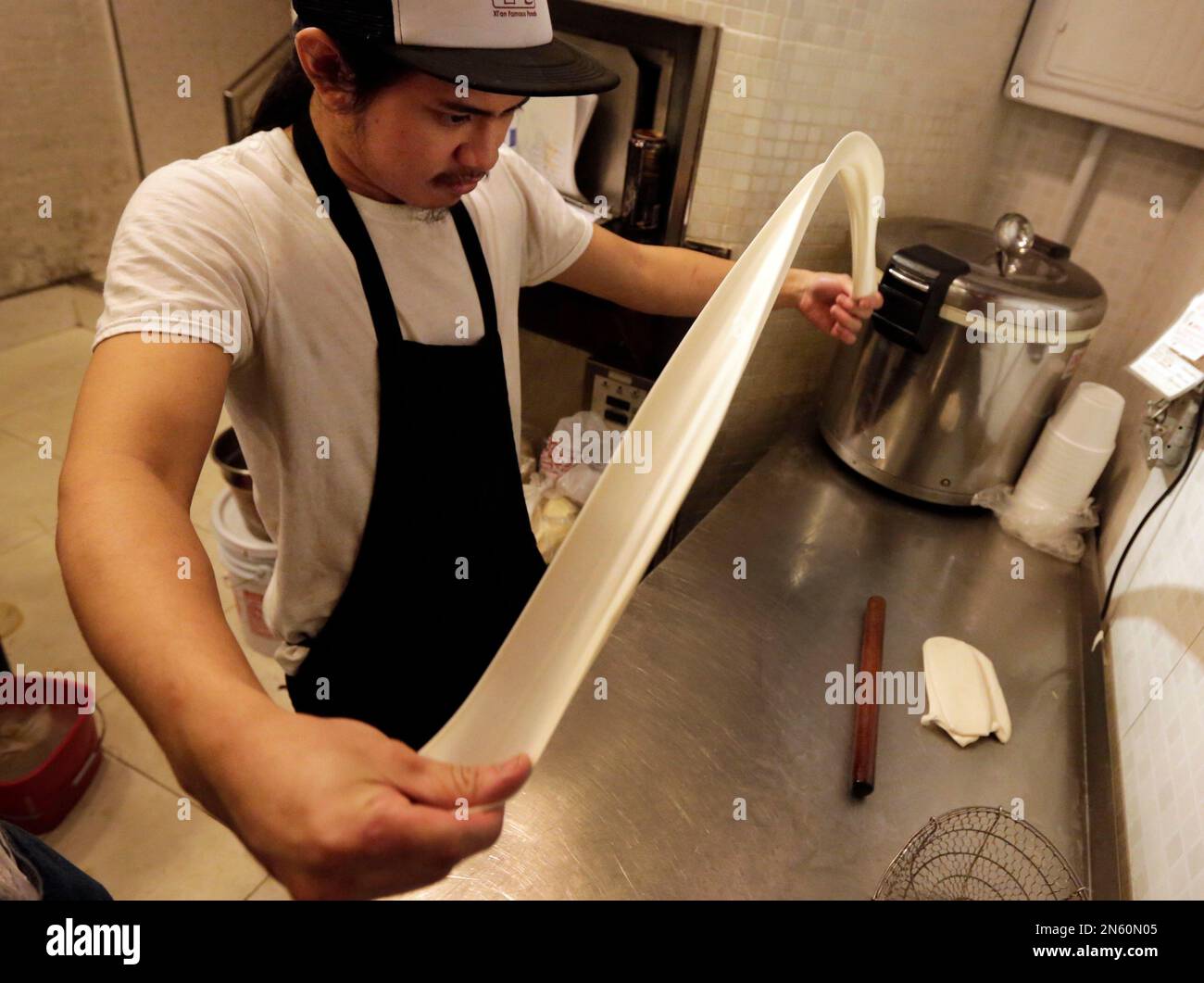 This Dec. 5, 2013 photo shows Leo Cardona making noodles at Xi'an ...