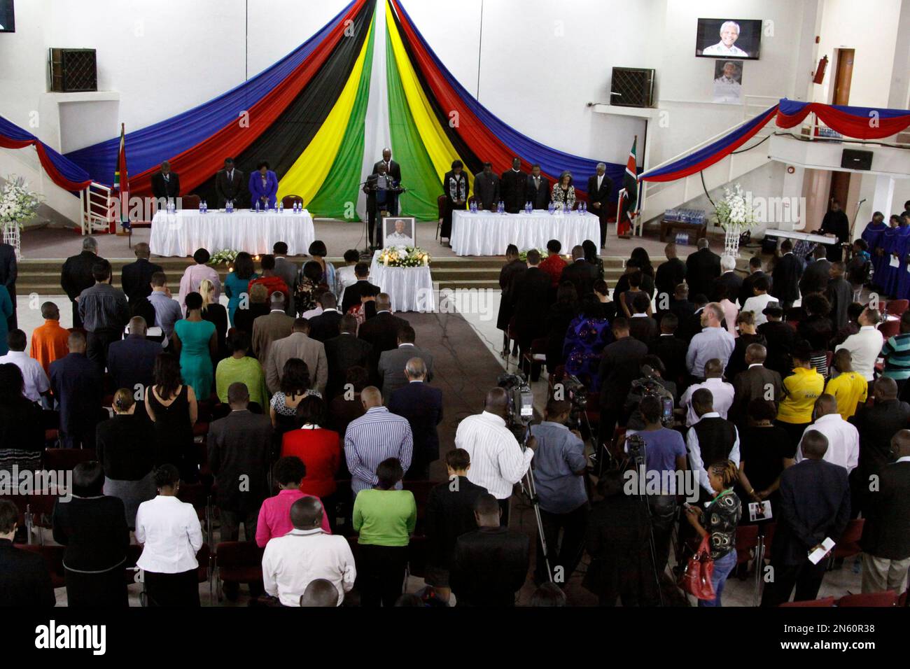People stand during a memorial service for former South African ...