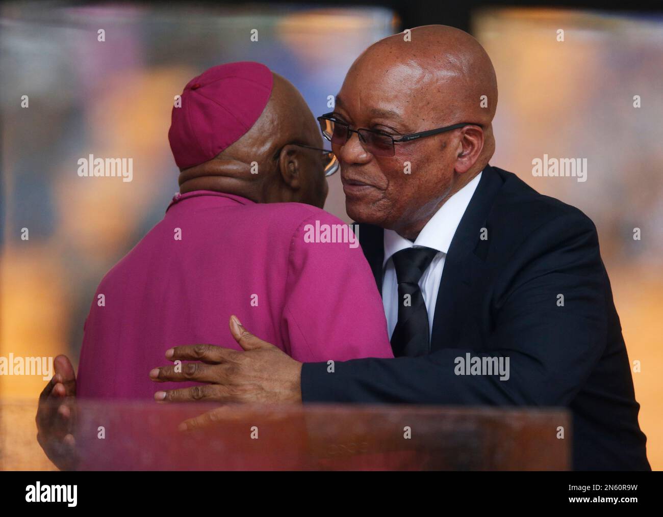 South African President Jacob Zuma, right, hugs Retired Anglican ...