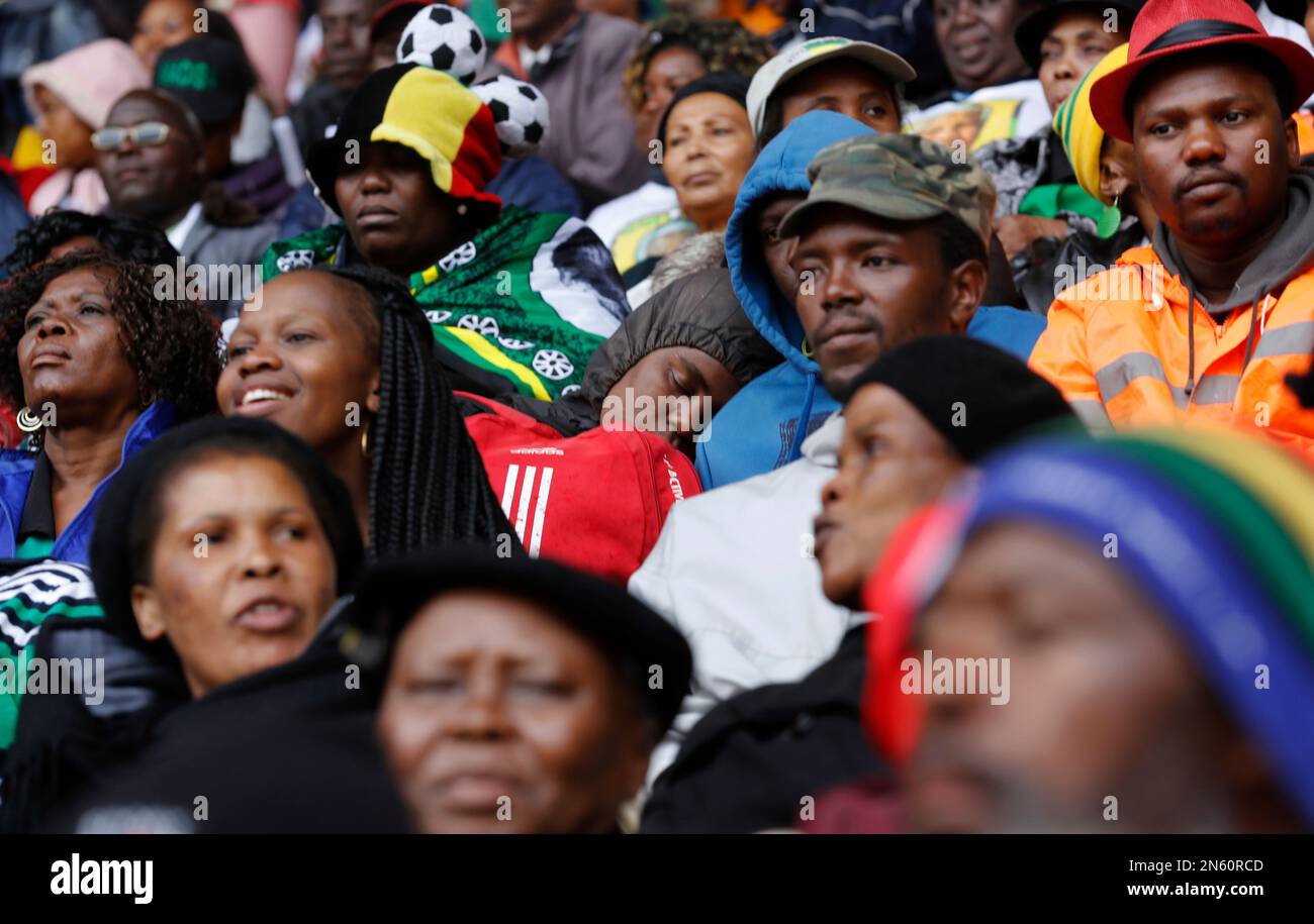 A mourner sleeps during the memorial service for former South African ...